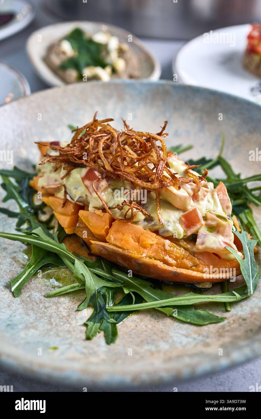 Loaded Baked Sweet Potato with Avocado Topping Stock Photo - Alamy