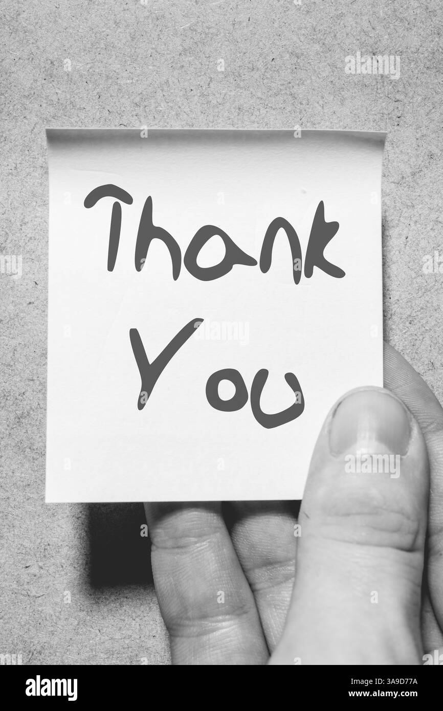 A thank you note on a brown wooden background Stock Photo - Alamy