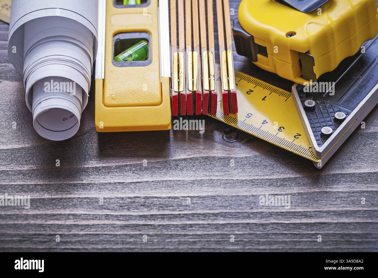 Wooden meter square ruler measuring tape rolled blueprints and ...