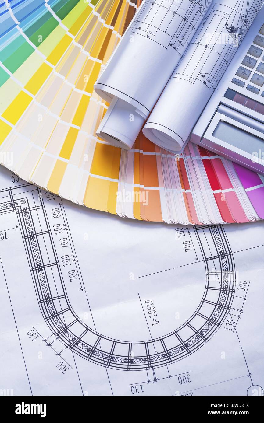 Rolled up blueprints on color palette and calculator Stock Photo - Alamy