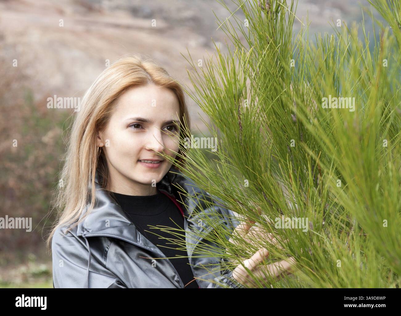 Portrait of a beautiful girl with a pine tree Stock Photo - Alamy