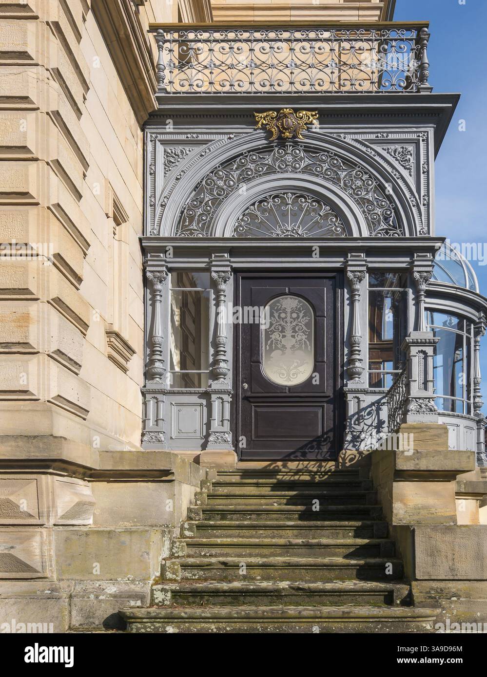 Historic door with filigree decorations and railings on a stone ...