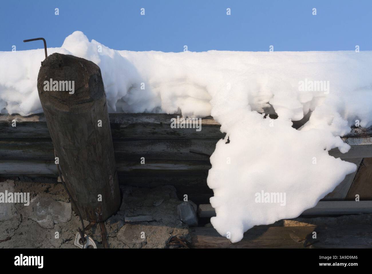 Wooden roof, drooping snow, winter, sunny, blue sky Stock Photo - Alamy