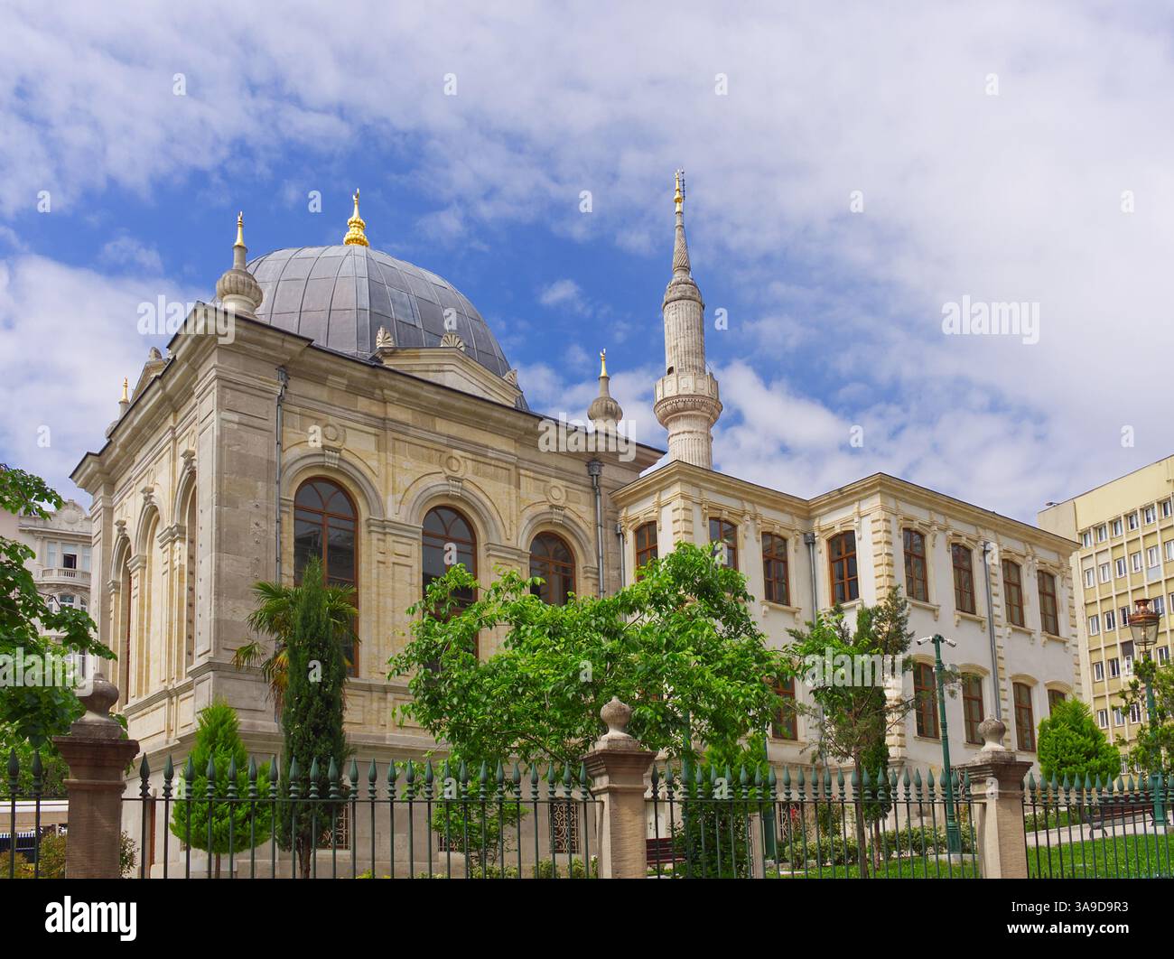 Ornate Ottoman-style mosque with domed roof and minaret, surrounded by ...