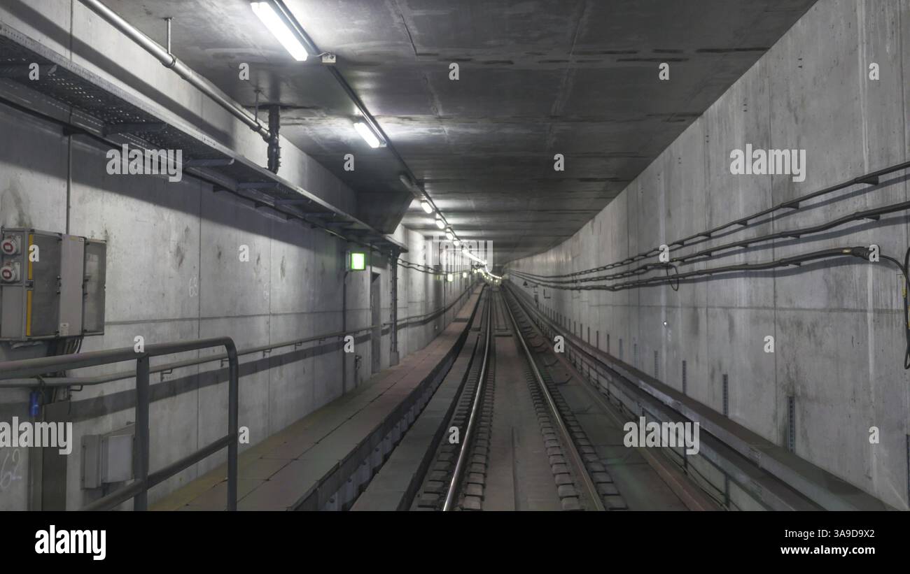 Subway rails in tunnel with wires on cement walls Stock Photo - Alamy
