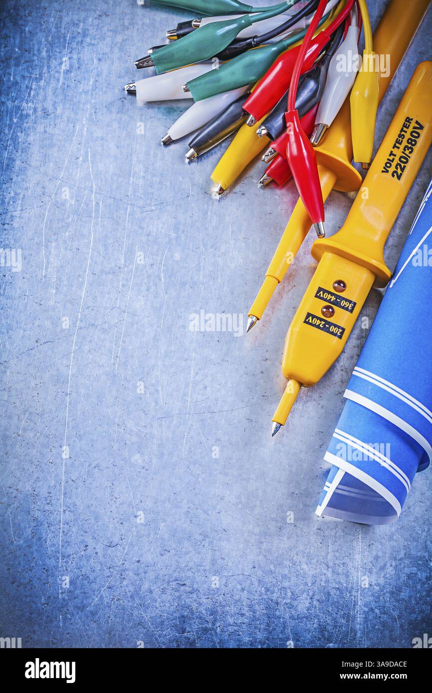 Yellow electrical tester crocodile cables set blue blueprints on ...