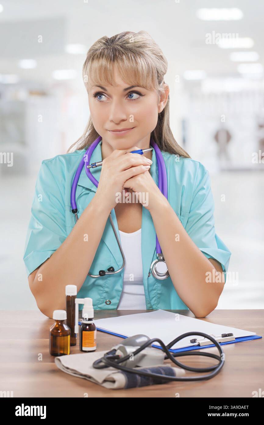 Beautiful female doctor thinking Stock Photo - Alamy
