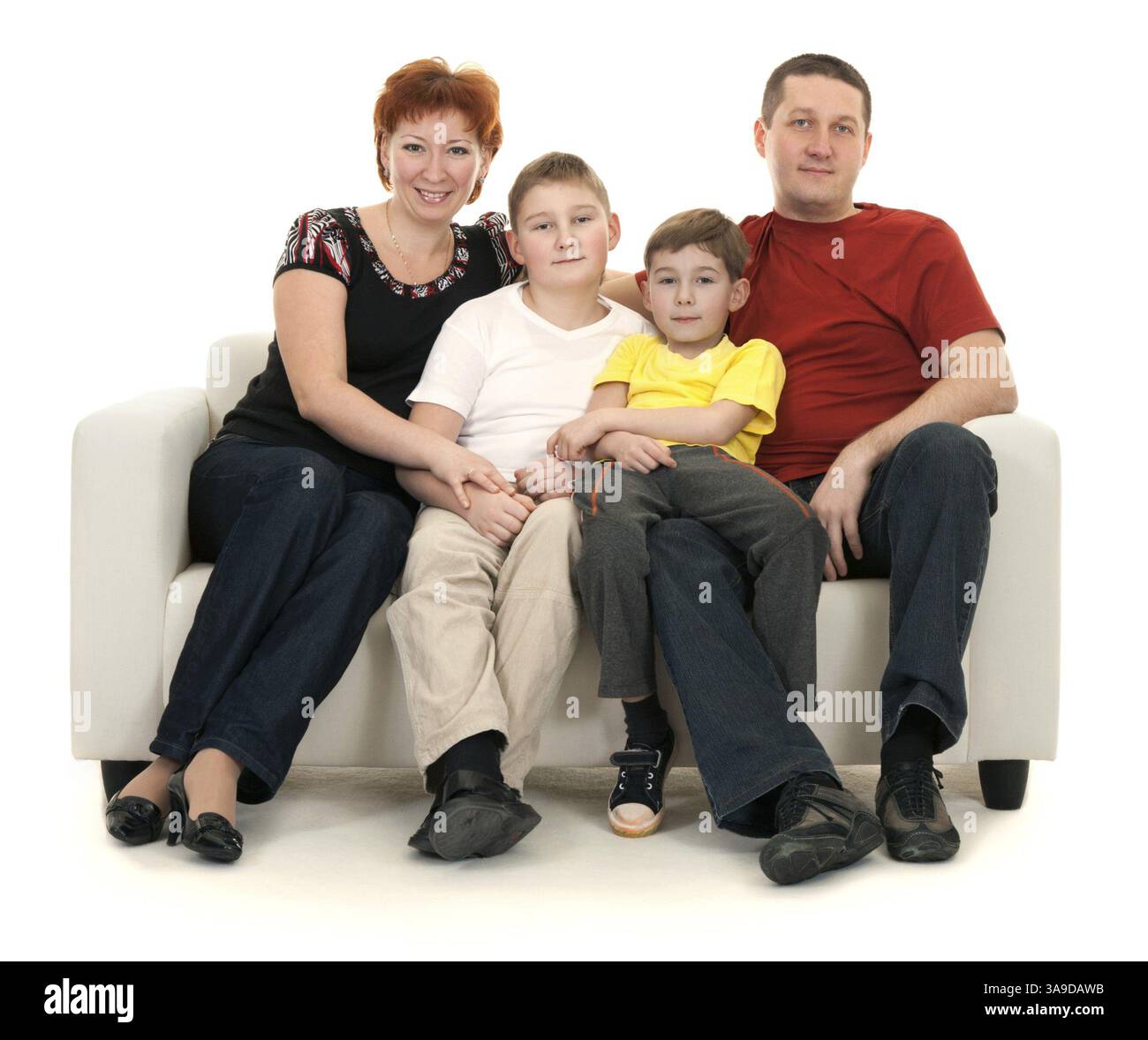 Family of four on a sofa on a white background Stock Photo - Alamy