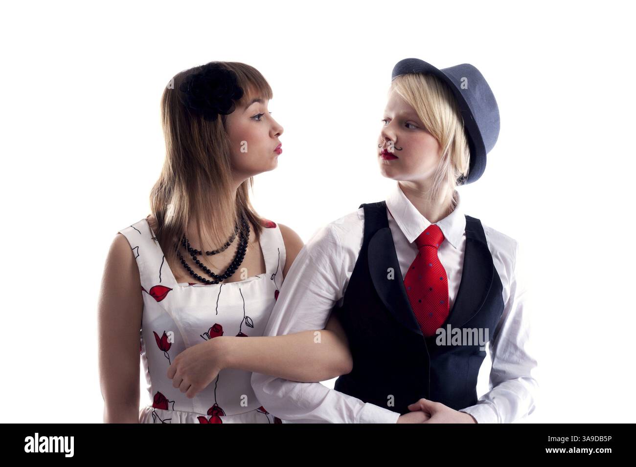 Two girls will wipe friend on friend, girl with drawn moustache in hat ...