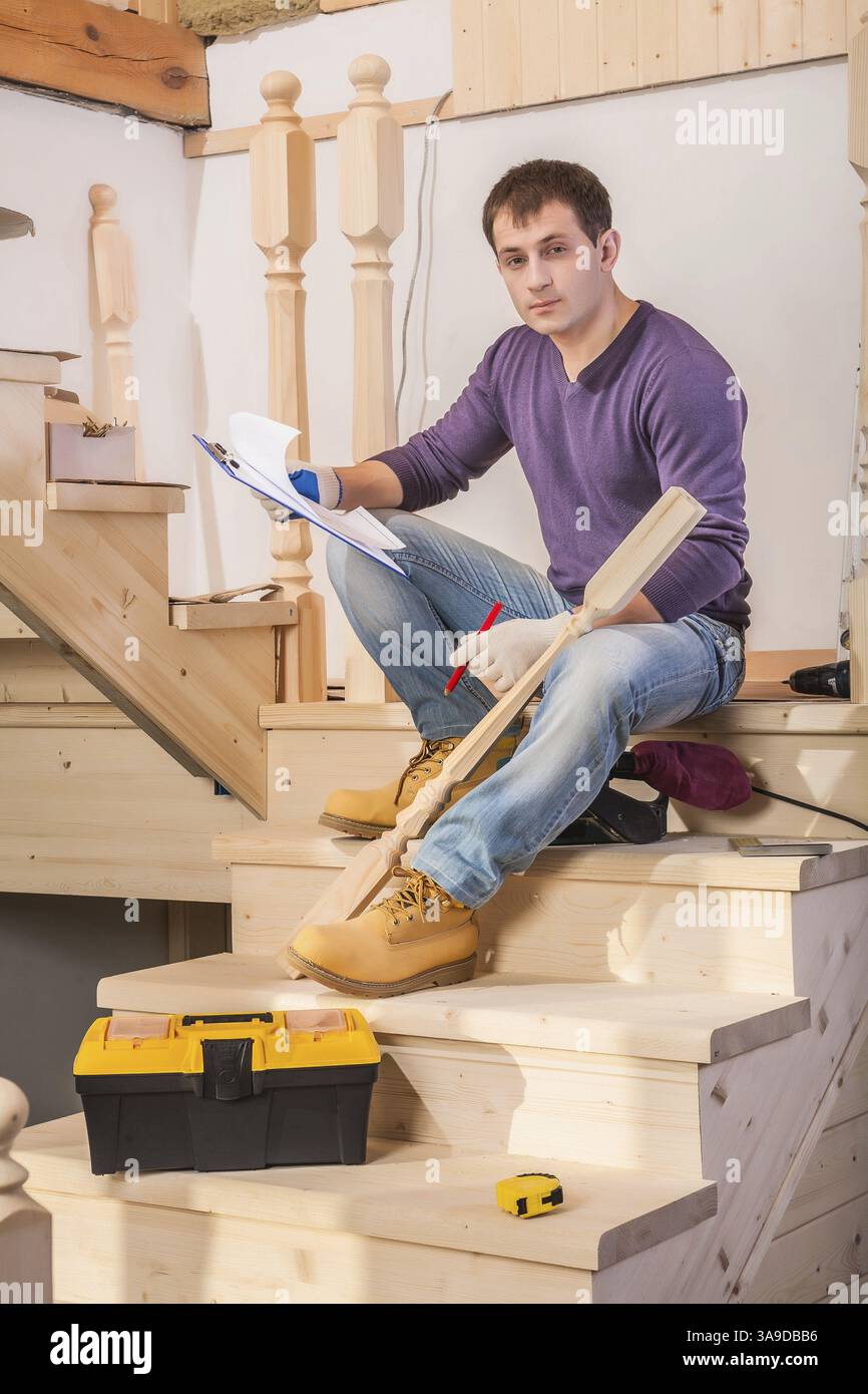 Carpenter on ladder Stock Photo - Alamy