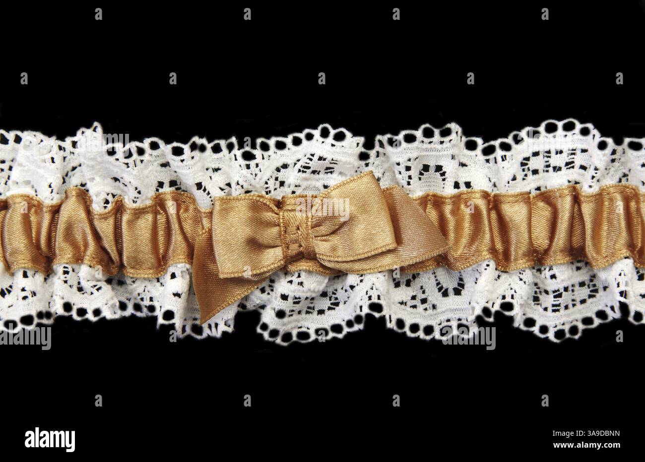 Blanching feminine garter with beige satin band on black background ...