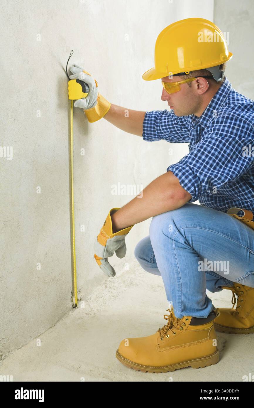 Worker with tape measure Stock Photo - Alamy