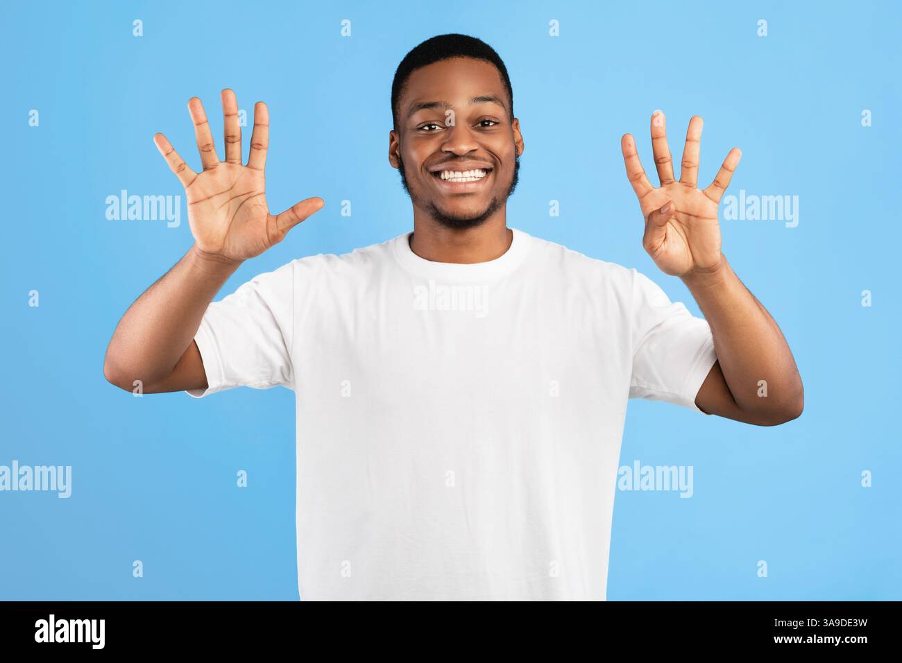 African Man Counting Showing Number Nine Standing In Studio Stock Photo ...