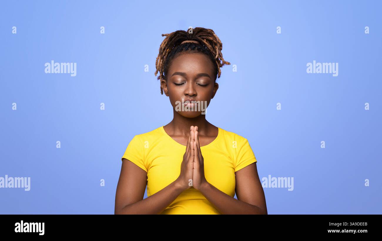 Young black woman showing clasped hands in pleading gesture Stock Photo ...