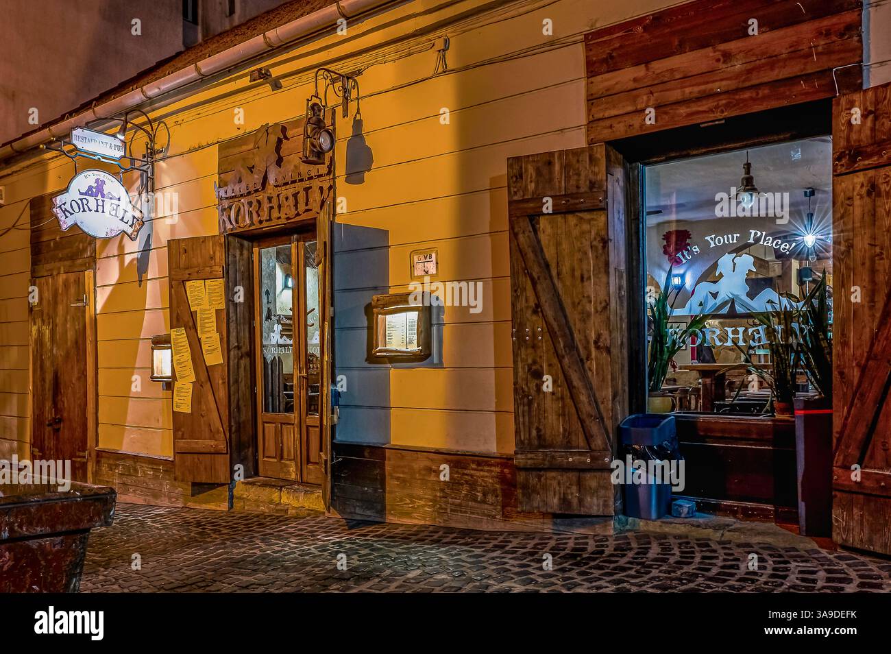 Authentic Hungarian restaurant on a small narrow back street, lit up at ...