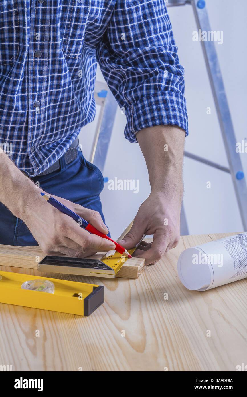 Carpenter drawing on wooden plank construction concept Stock Photo - Alamy