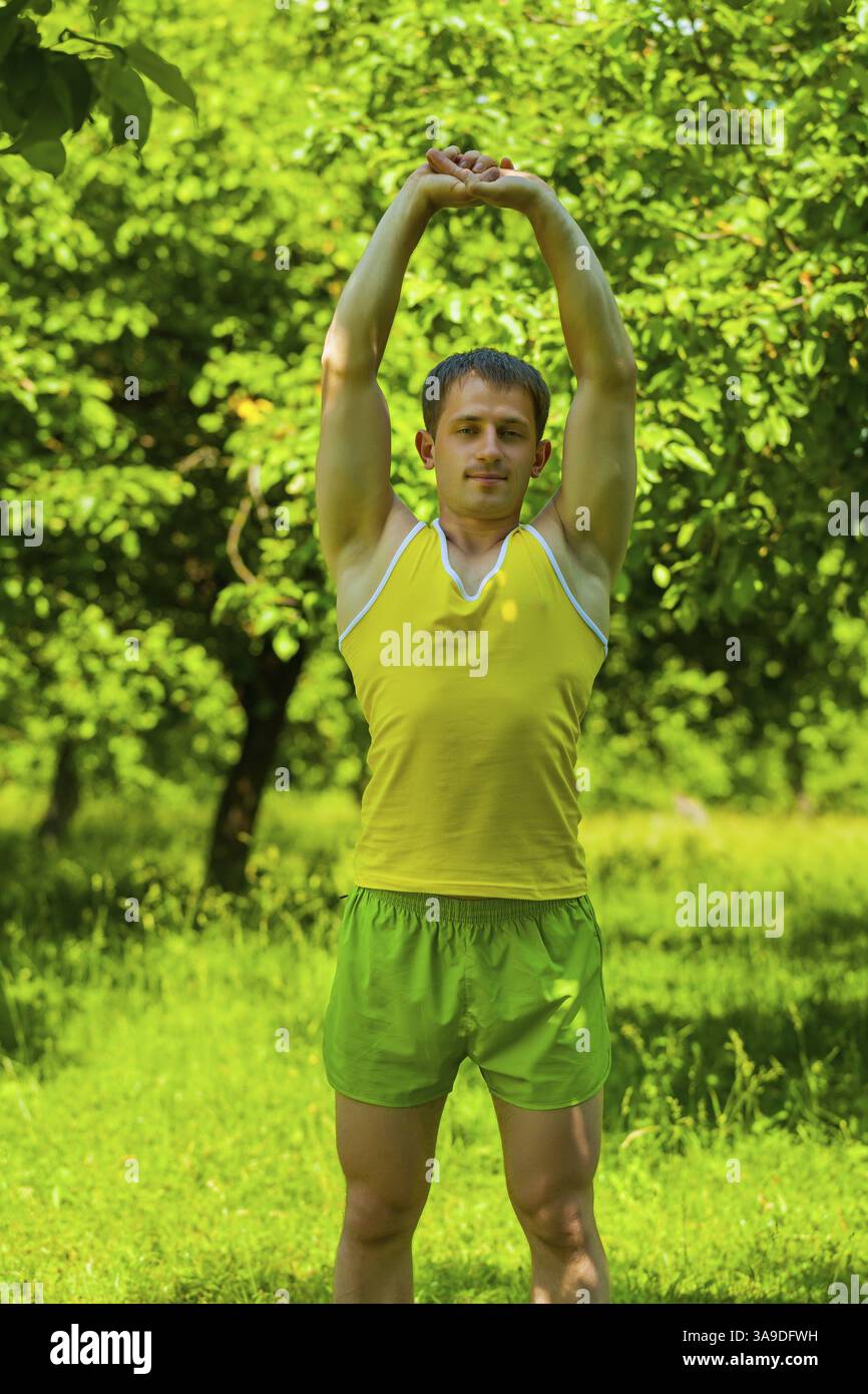 A young man do stretching muscles of arms Stock Photo - Alamy