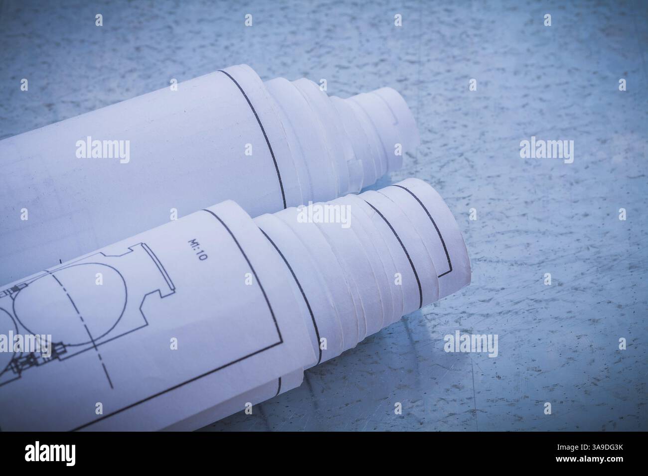 Rolled construction drawings on metallic background horizontal view ...