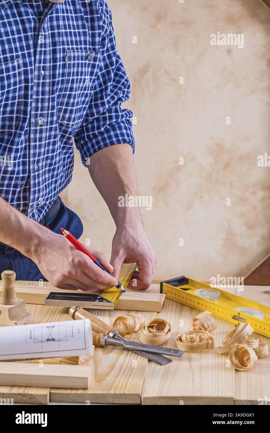 Carpenter drawing on wooden plank construction concept Stock Photo - Alamy