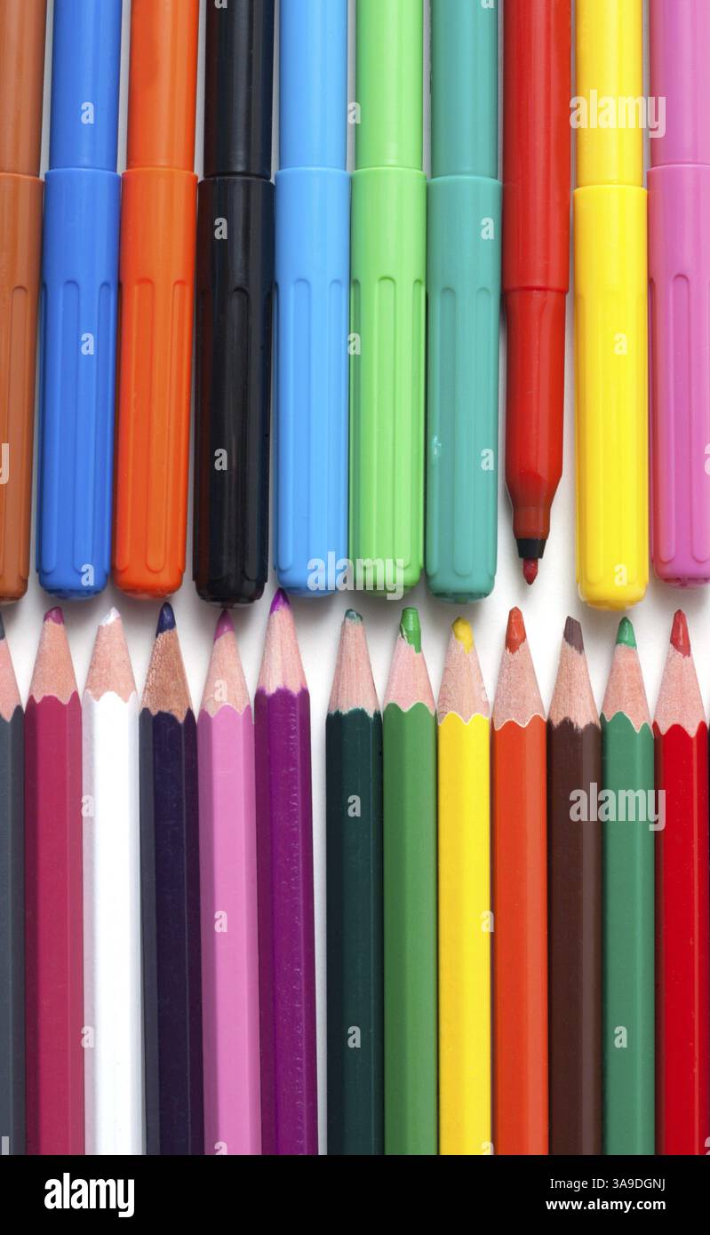 Crayons and soft-tip pens to rest upon white background Stock Photo - Alamy