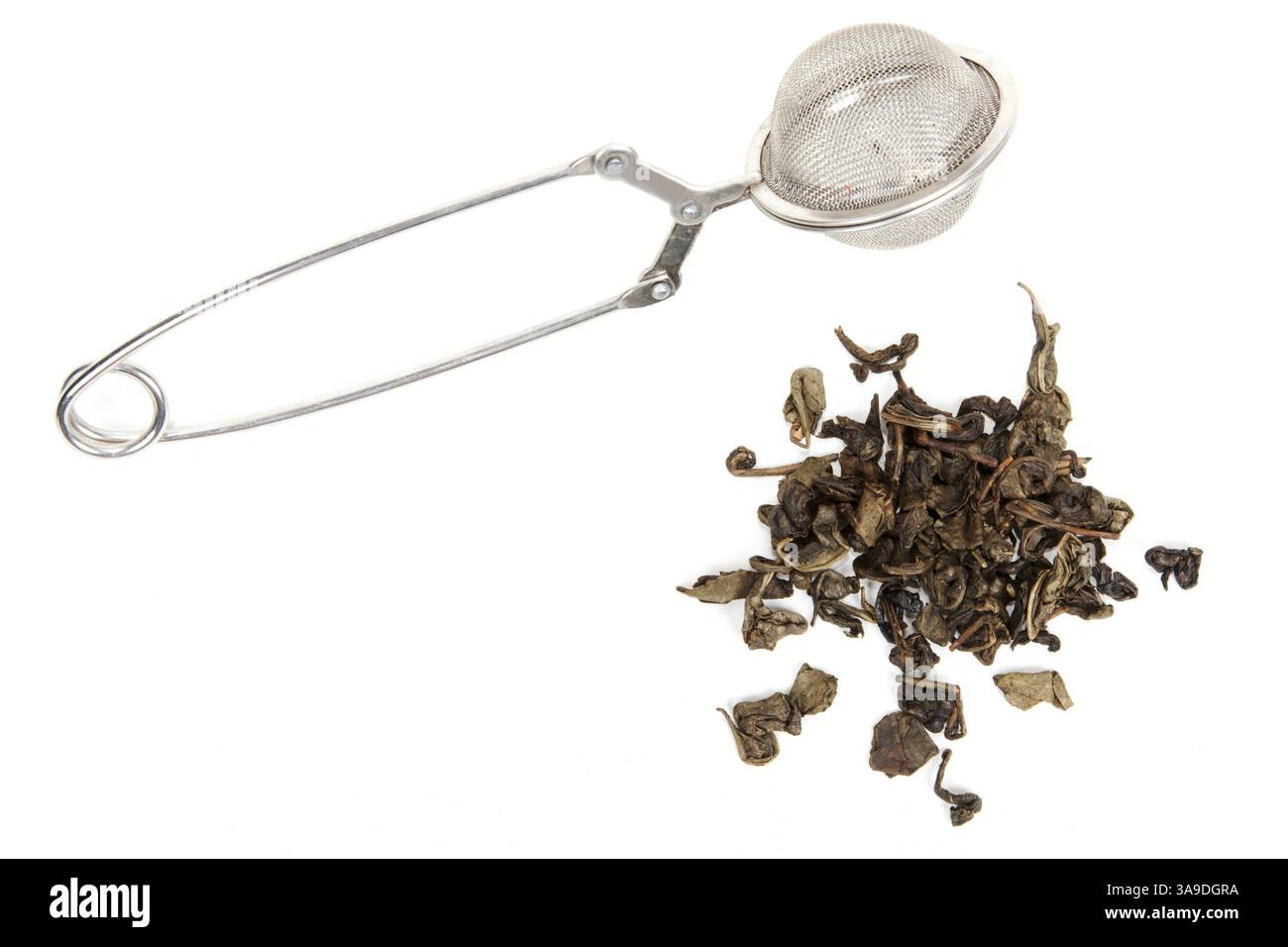 Dry green tea and strainer on white background Stock Photo - Alamy