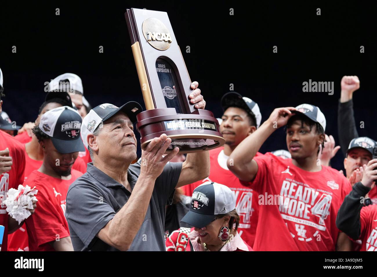 Houston head coach Kelvin Sampson holds the Midwest Region championship ...