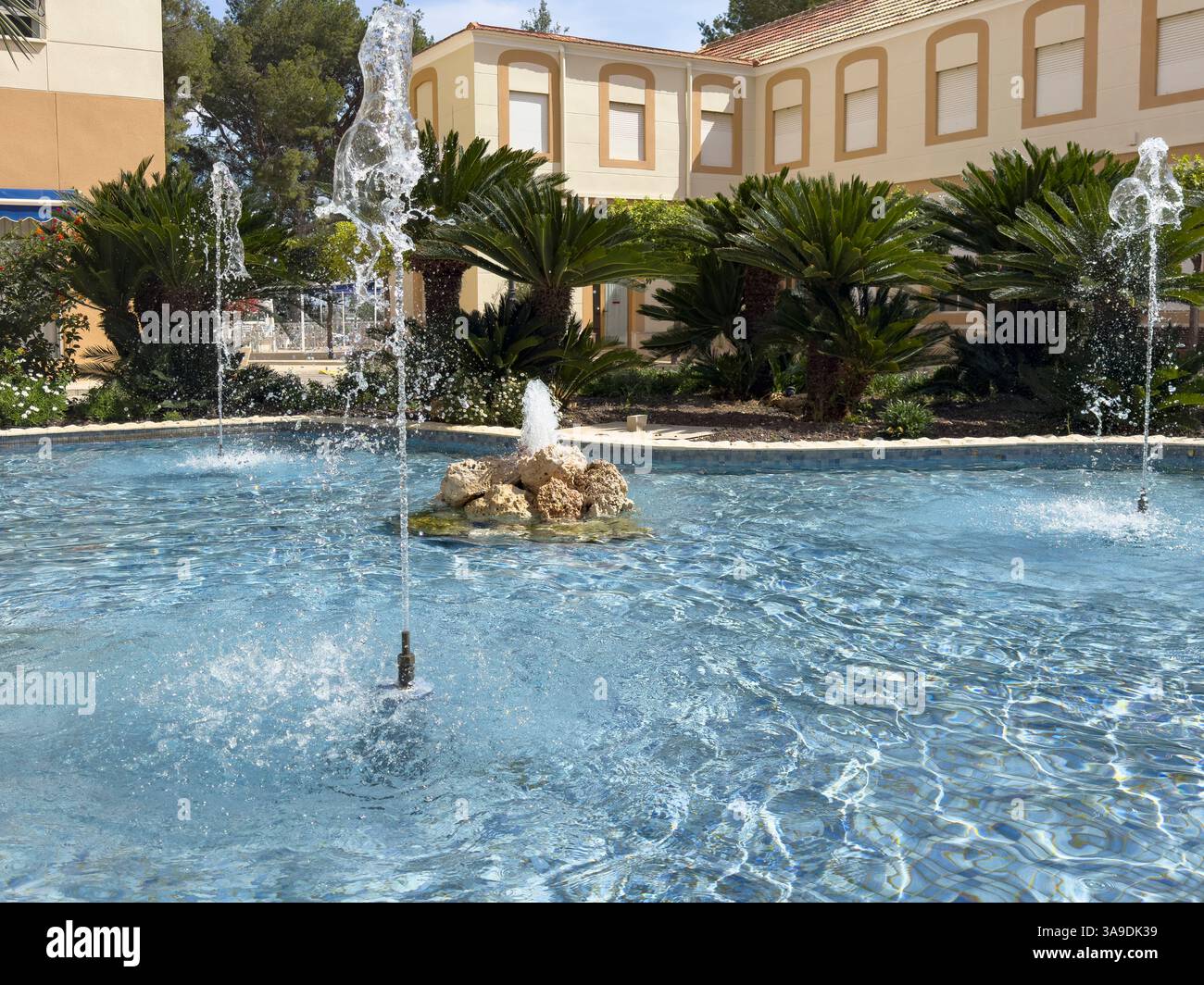 See an urban fountain's green decor, a residential oasis with abundant ...