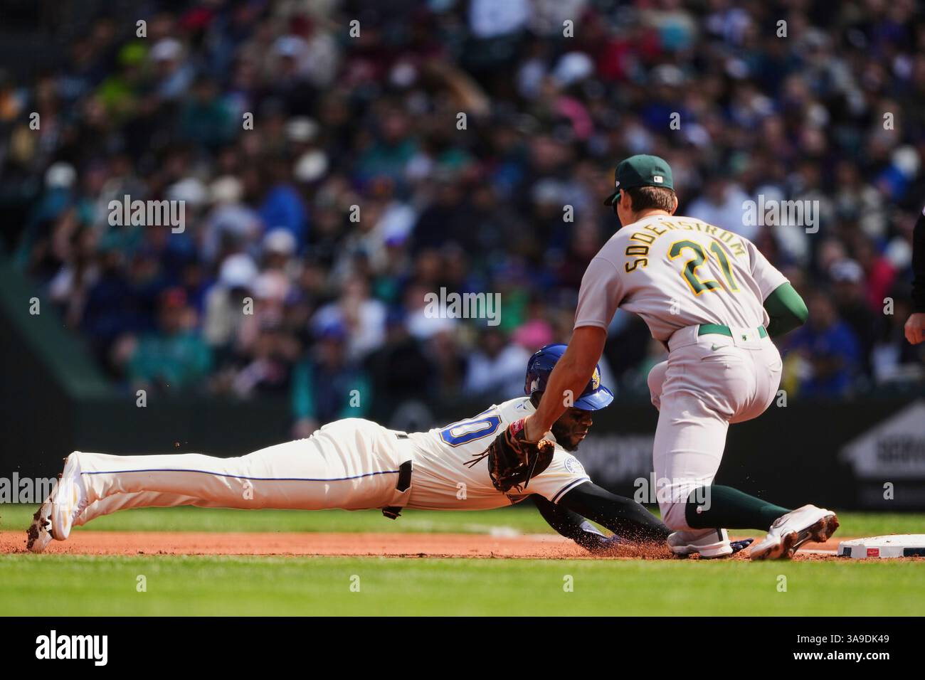 Seattle Mariners' Victor Robles returns to the base to beat a pickoff ...