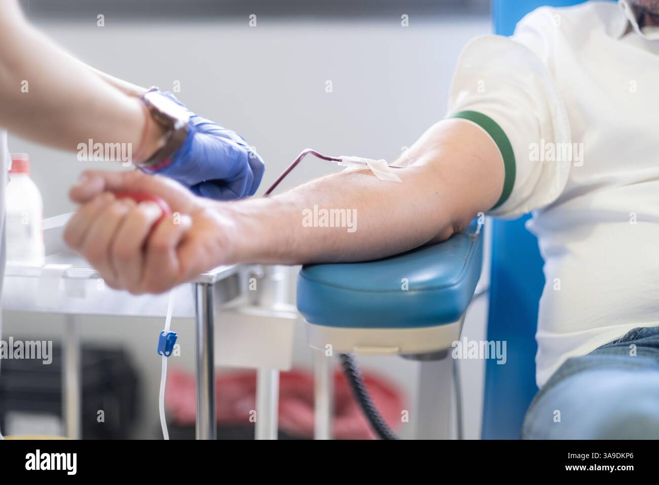 The hands of an anonymous nurse work to ensure the blood catheter ...