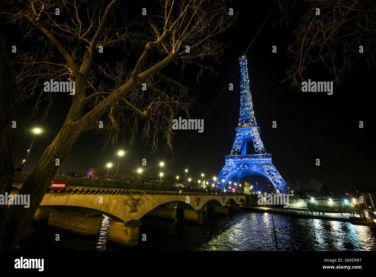 The Eiffel Tower is illuminated in blue as part of the international ...
