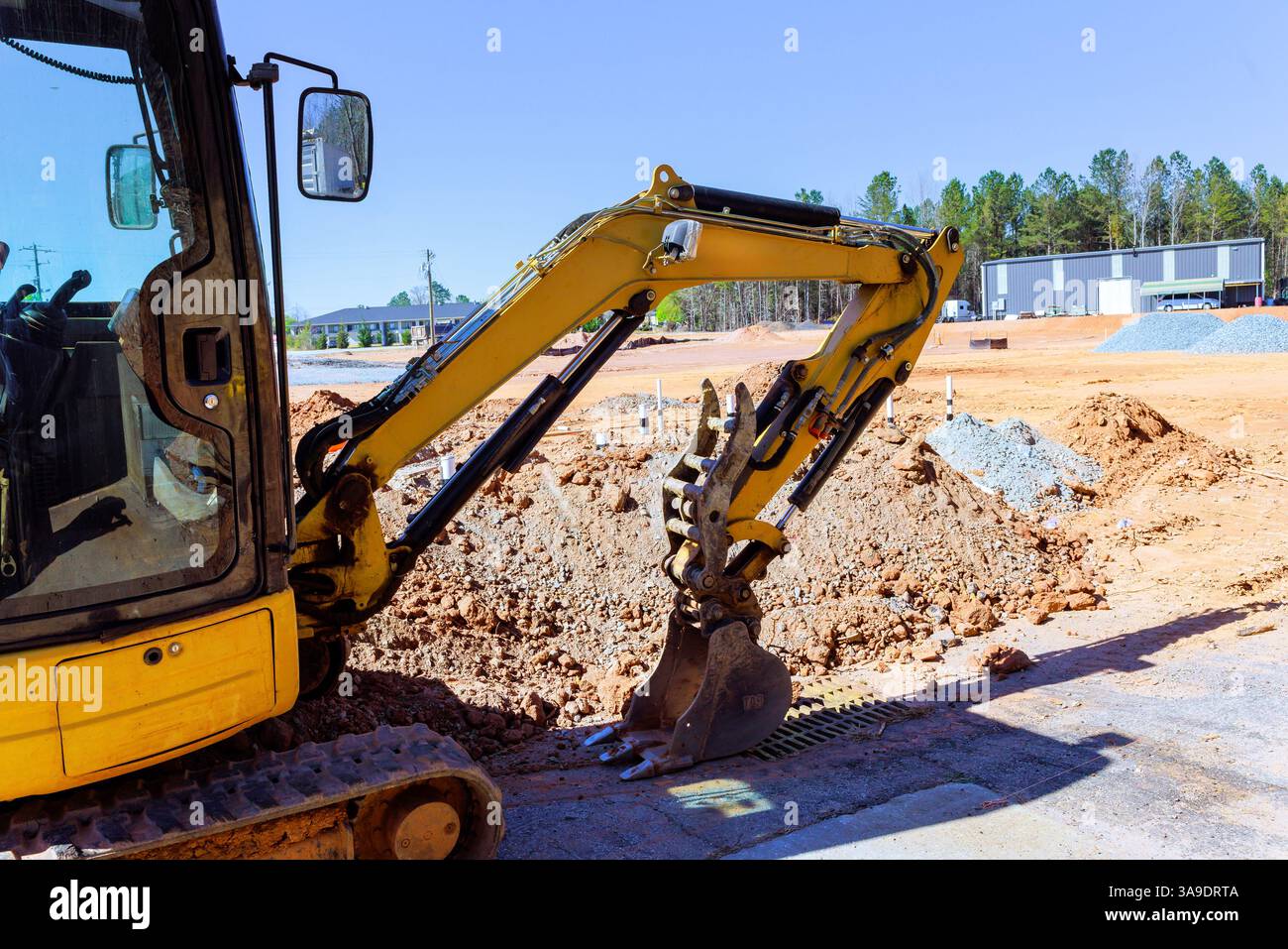 Heavy excavator machinery is actively digging into ground at ...