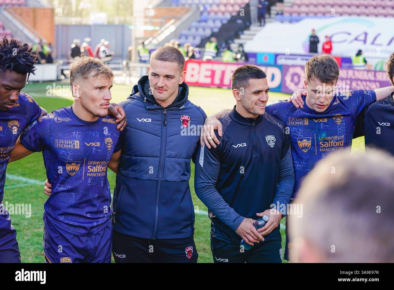 Salford team huddle after the game. Wigan, England. 30th March 2025 ...