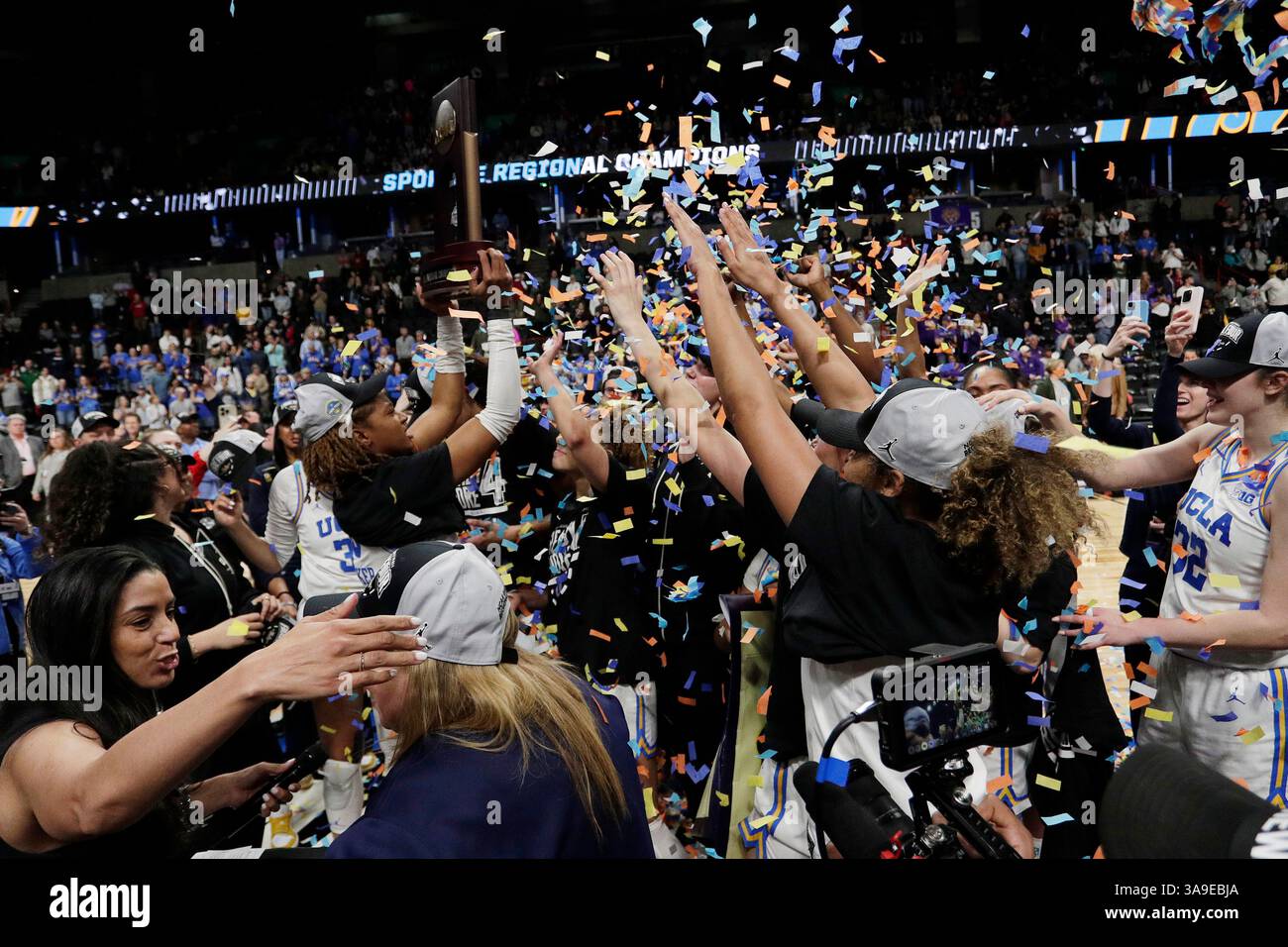 UCLA players celebrate with the trophy after their win against LSU in ...