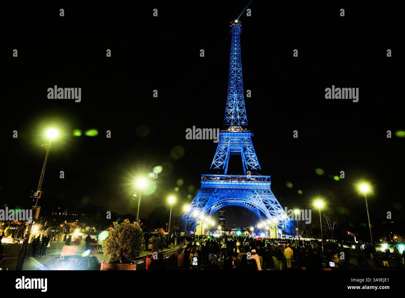 The Eiffel Tower is illuminated in blue as part of the international ...