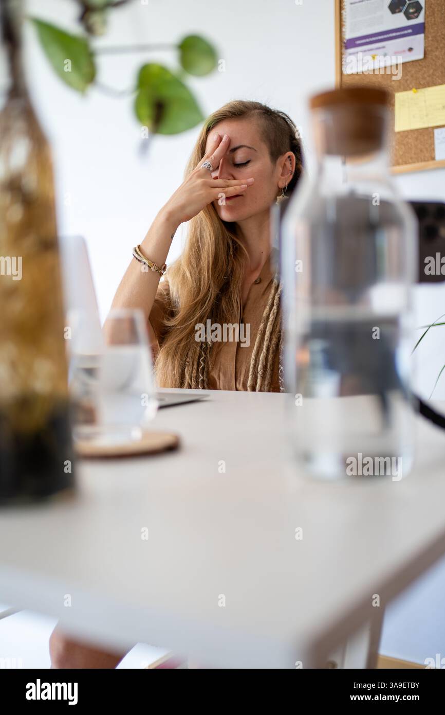A Stressed Woman in Her Home Office Effectively Managing Work Pressure ...