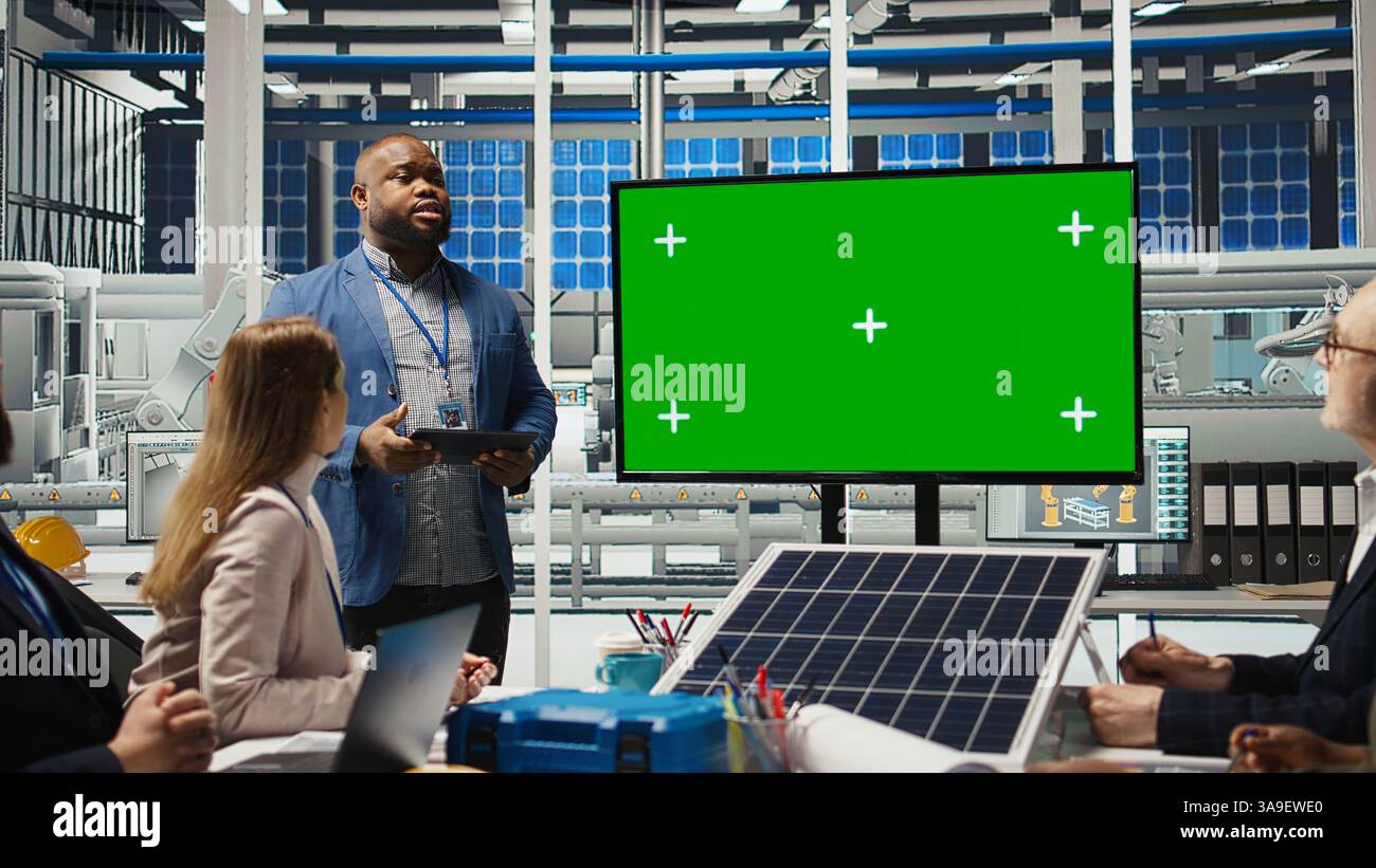 Factory shareholders chat about company growth, looking at green screen ...