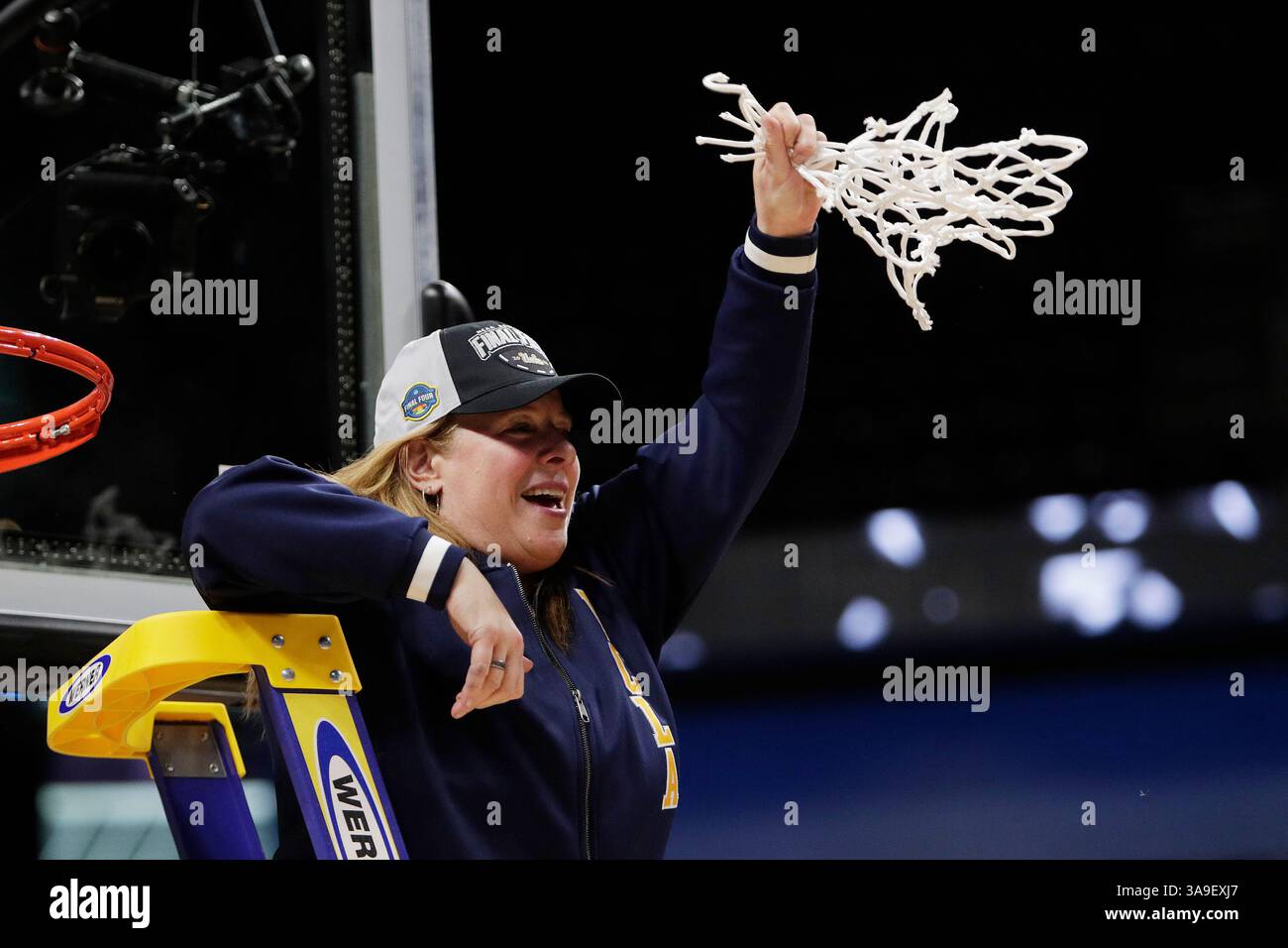 UCLA head coach Cori Close holds the net after the team's win over LSU ...