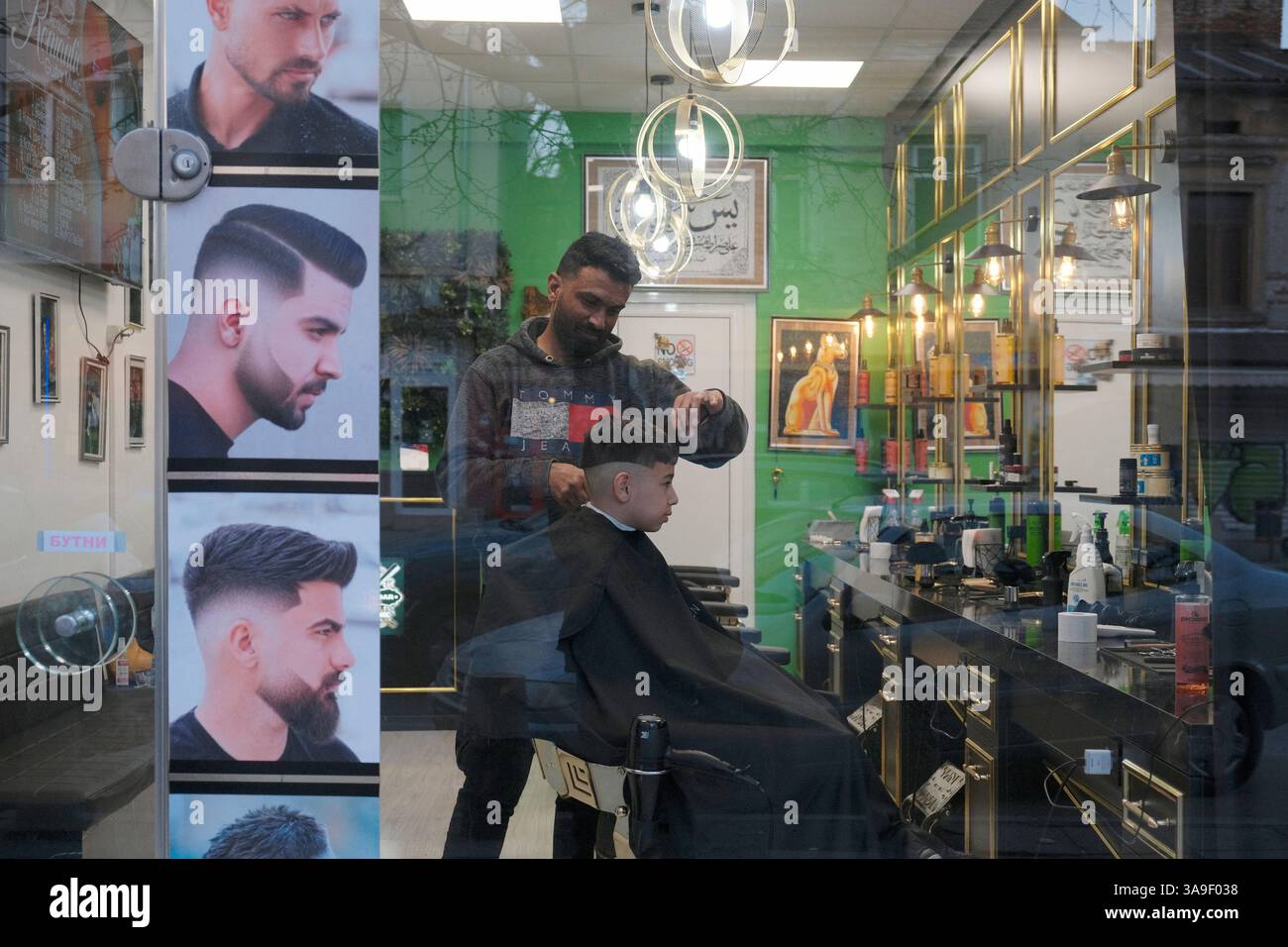 Bulgaria, Sofia; 9 March 2025, bulgarian kid having his hair cut in a local barber shop ...