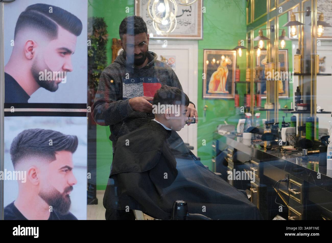 Bulgaria, Sofia; 9 March 2025, bulgarian kid having his hair cut in a local barber shop ...