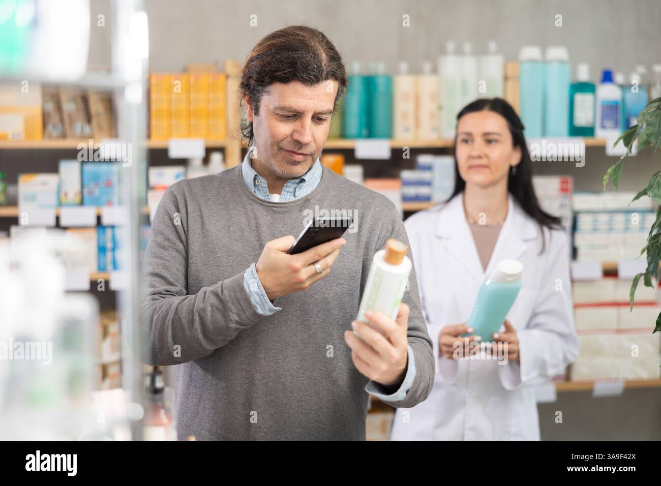 Man scans QR code on medicated shampoo label. Female pharmacist offers ...