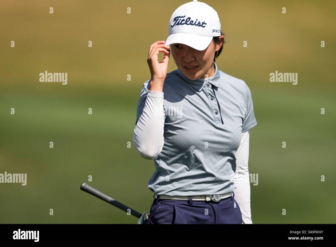 Yahui Zhang, of China, tips her cap on the third green during the final ...