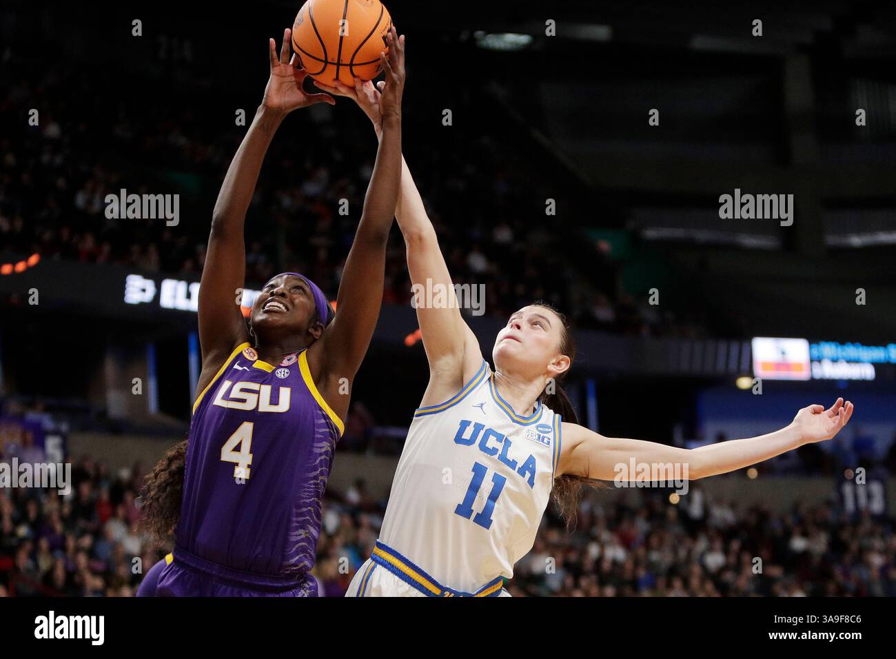 LSU guard Flau'Jae Johnson (4) and UCLA guard Gabriela Jaquez (11) go ...