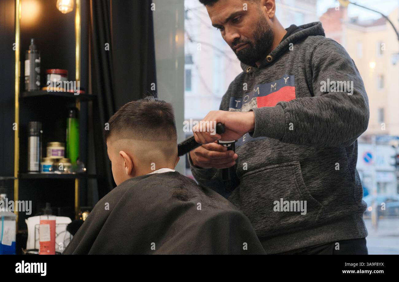 Bulgaria, Sofia; 9 March 2025, bulgarian kid having his hair cut in a local barber shop ...