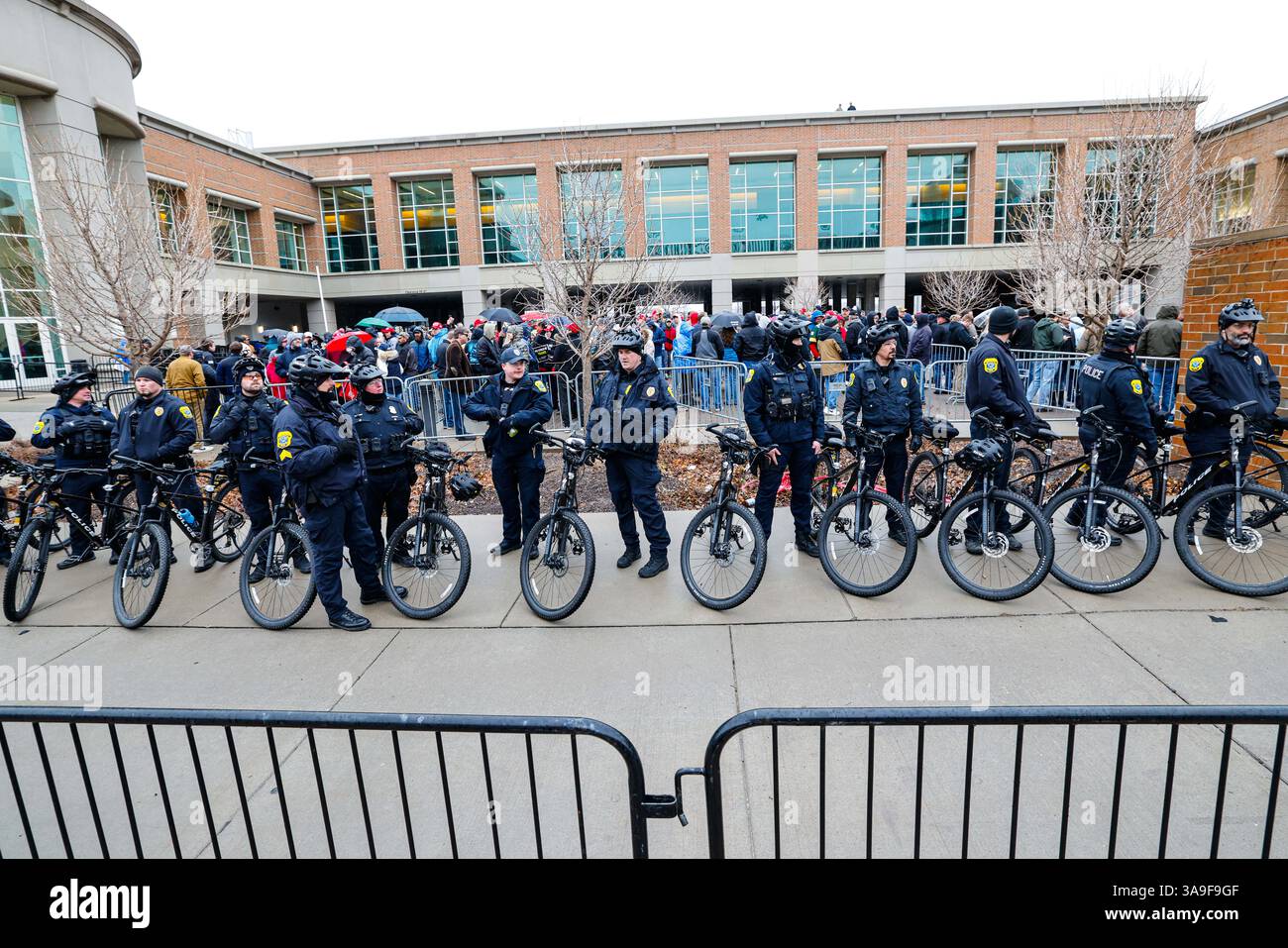 Police line up as people arrive for a town hall with Elon Musk, Sunday ...