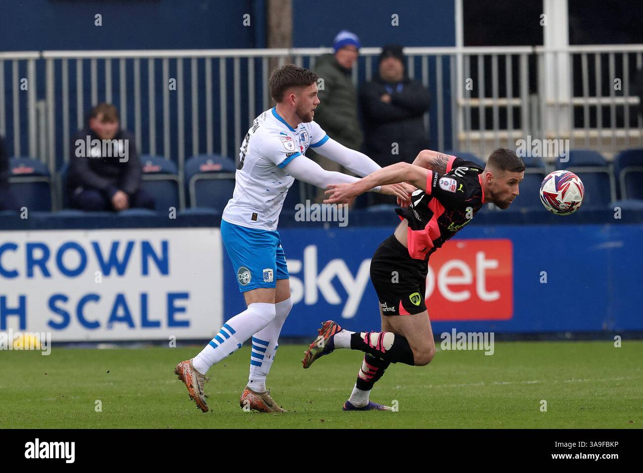 Chesterfield's Ryan Colclough in action with Barrow's Ben Jackson ...
