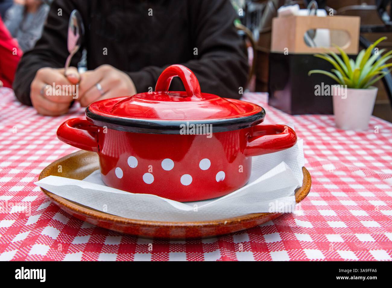 Dining out in the restaurant. Woman is holding the spoon and going to ...