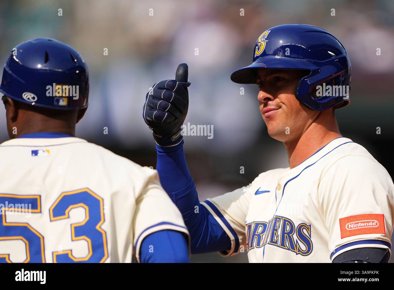 Seattle Mariners' Dylan Moore gives a thumbs-up after hitting a single ...