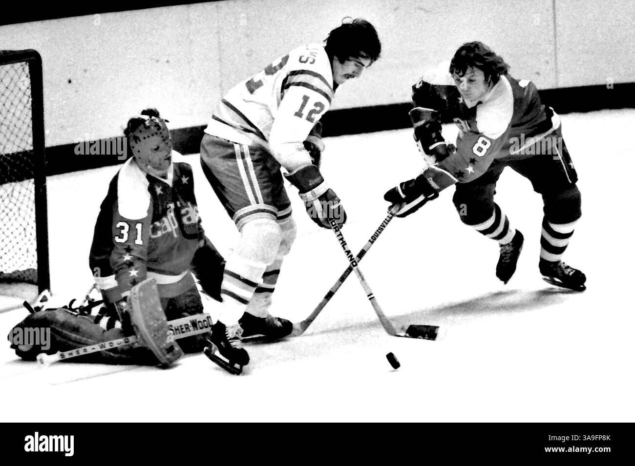 California Golden Seals Butch Williams (12) tries to get puck past ...