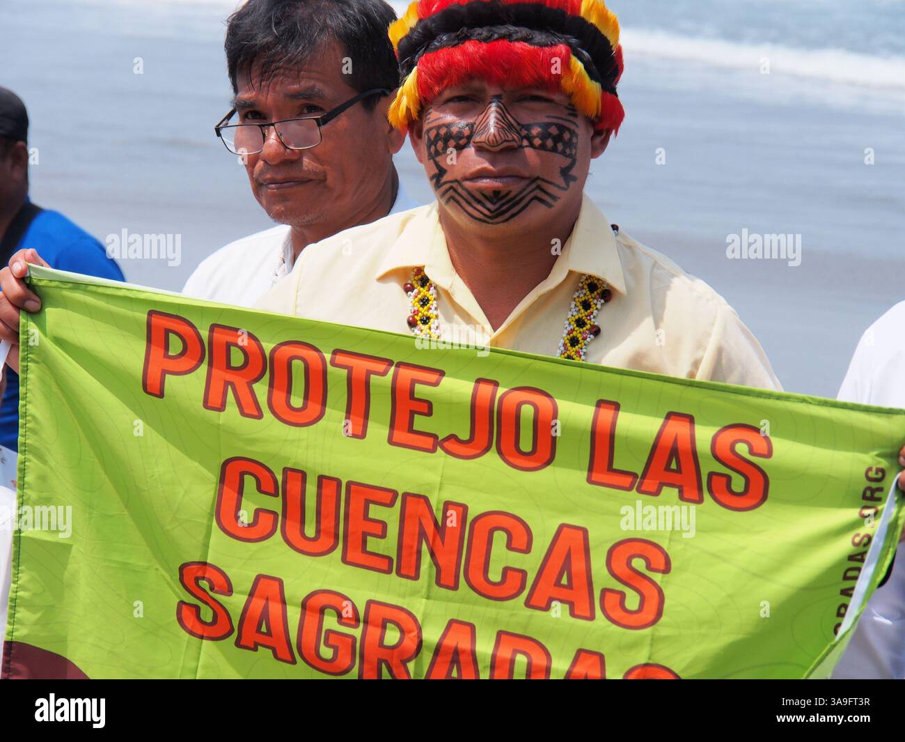 "I protect the sacred basins" can be read on a banner when indigenous ...