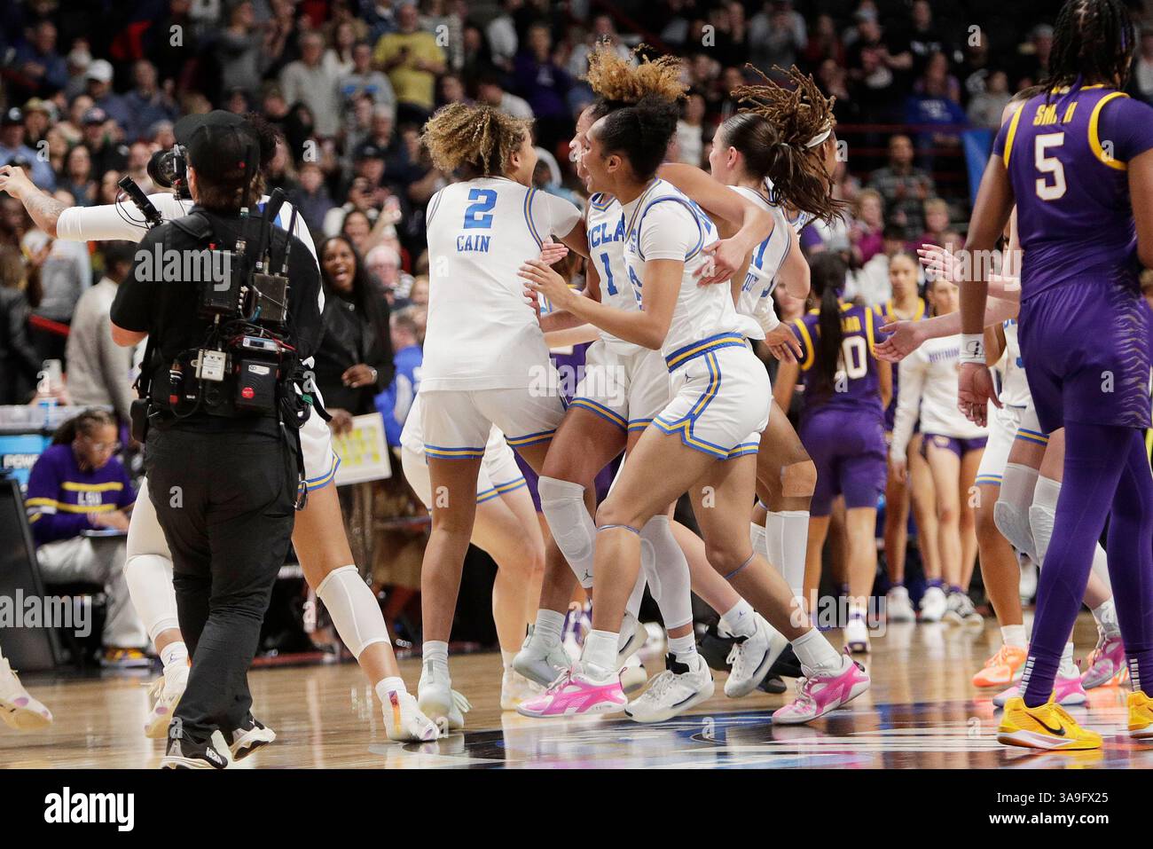 UCLA players celebrate their win against LSU in the Elite Eight of the ...